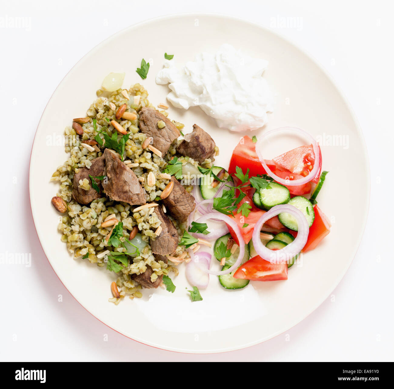 Beef, cooked with onion and spices and served on a bed of frikeh (or ...