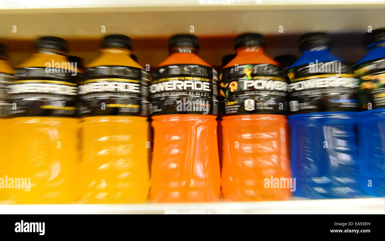 Various flavors of Powerade sports drink sit on a shelf in a store on ...