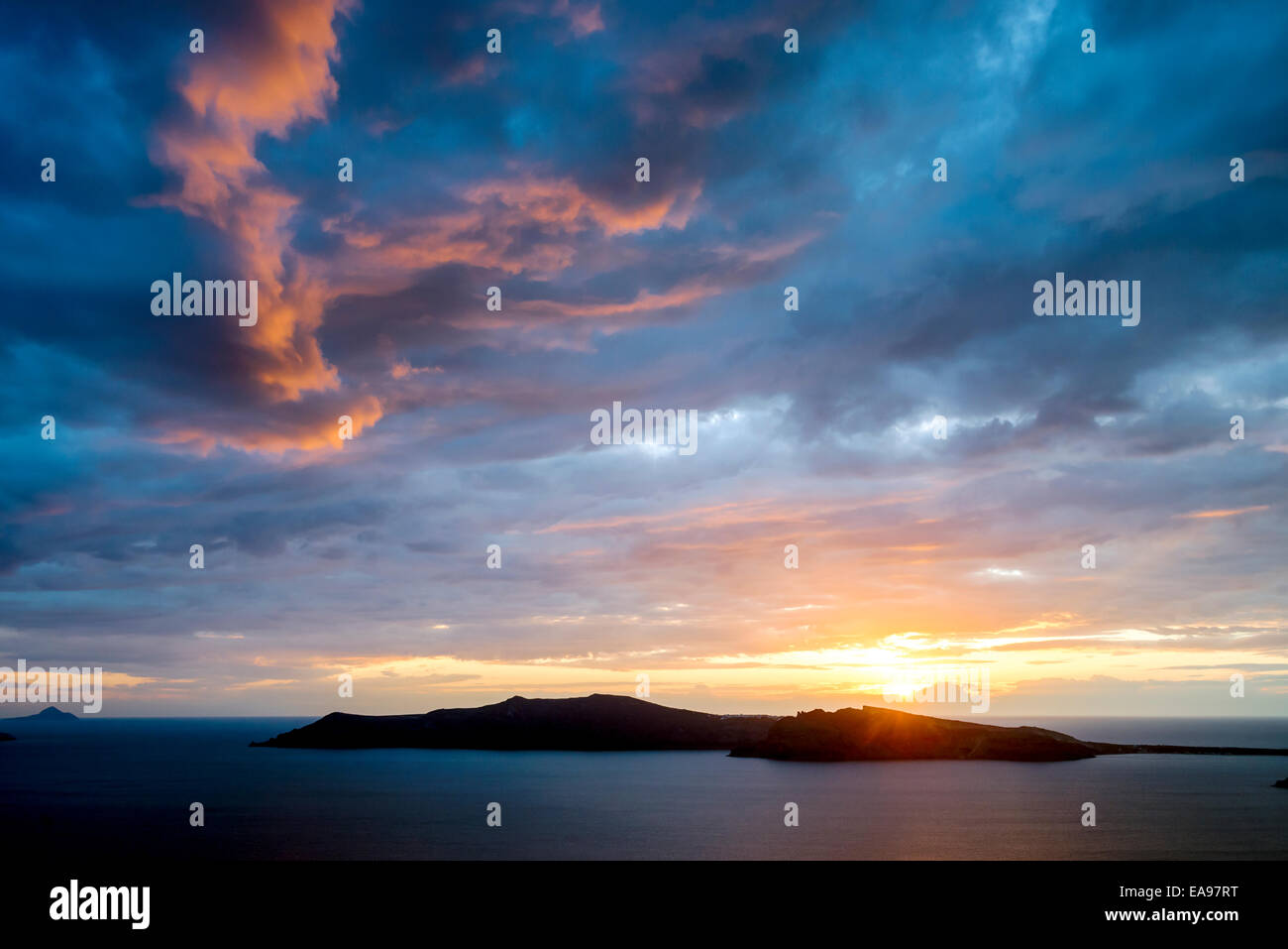 Spectacular sunset over the Aegean volcanic island caldera of Santorini ...