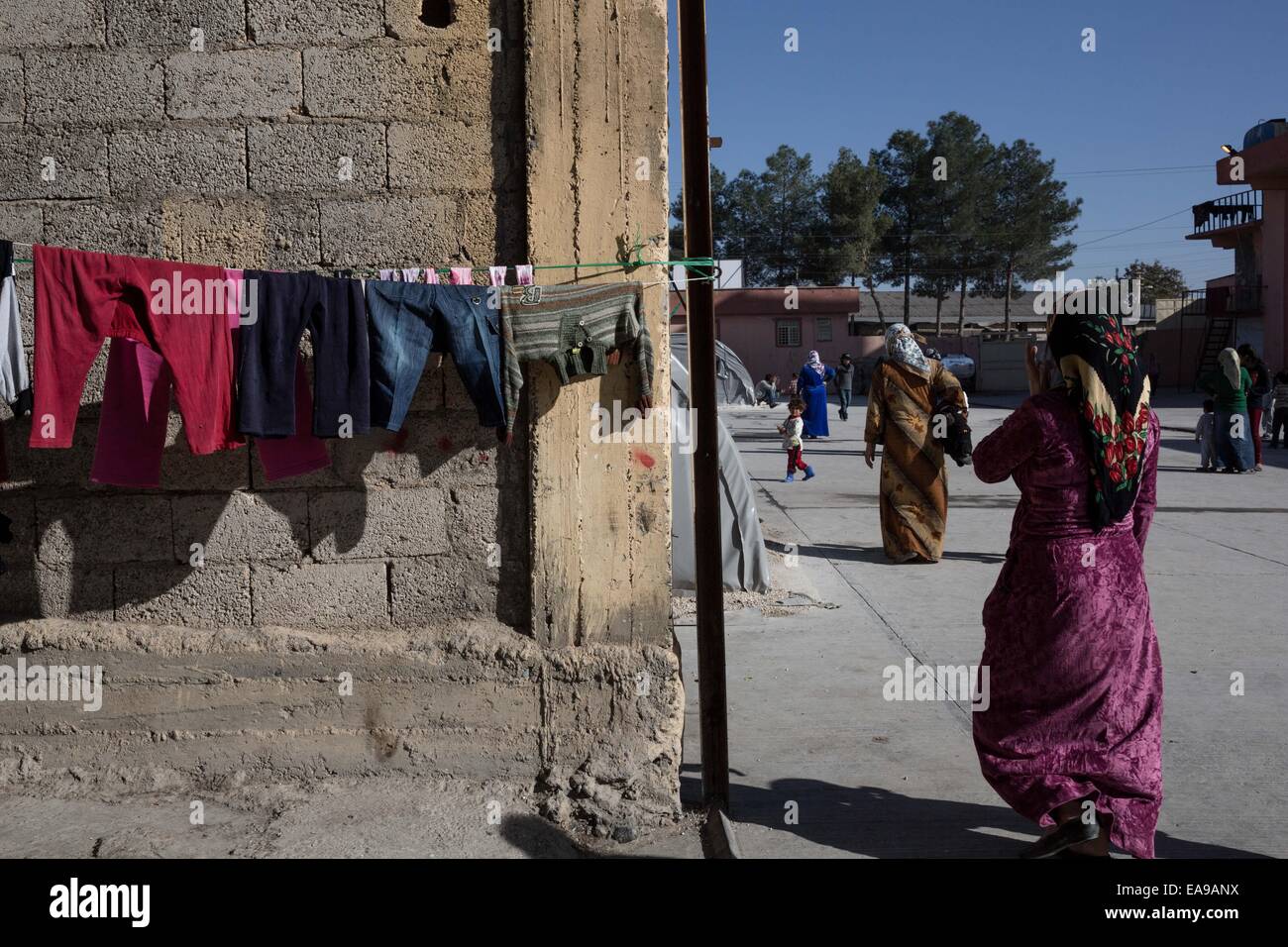 Kurdish refugees from Kobane inside a factory used as a refugee camp ...