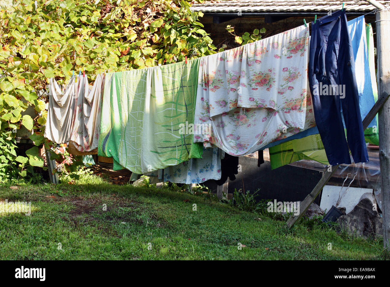 Clothes hanging to dry on a laundry line outdoor Stock Photo - Alamy