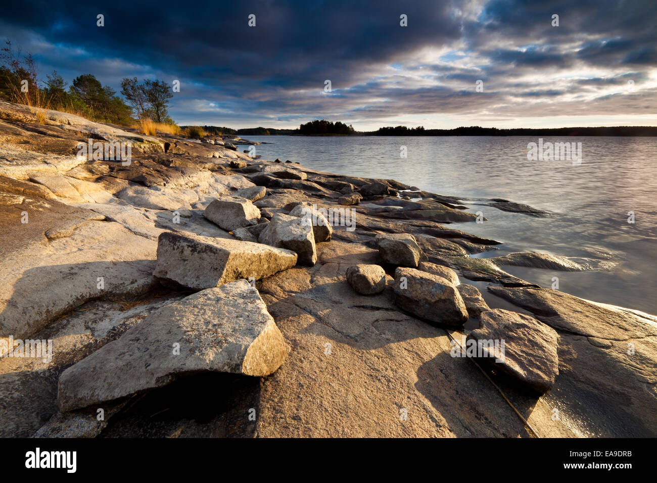 Rocky lakeside at the island Brattholmen in the lake Vansjø in Østfold ...