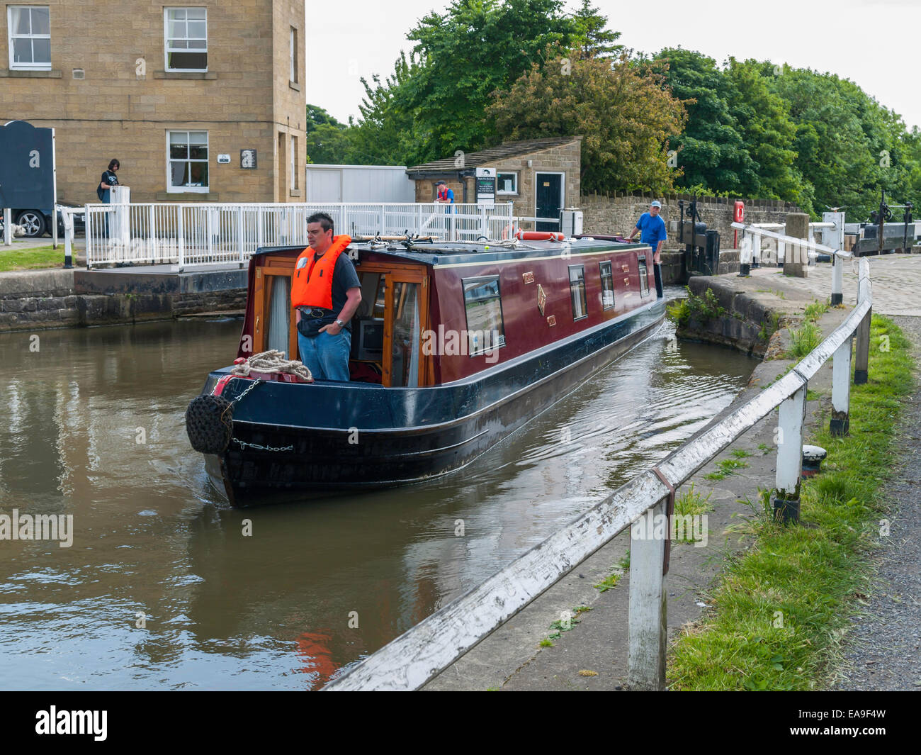 A narrow boat enters the top of the 5 rise locks on the Leeds and ...
