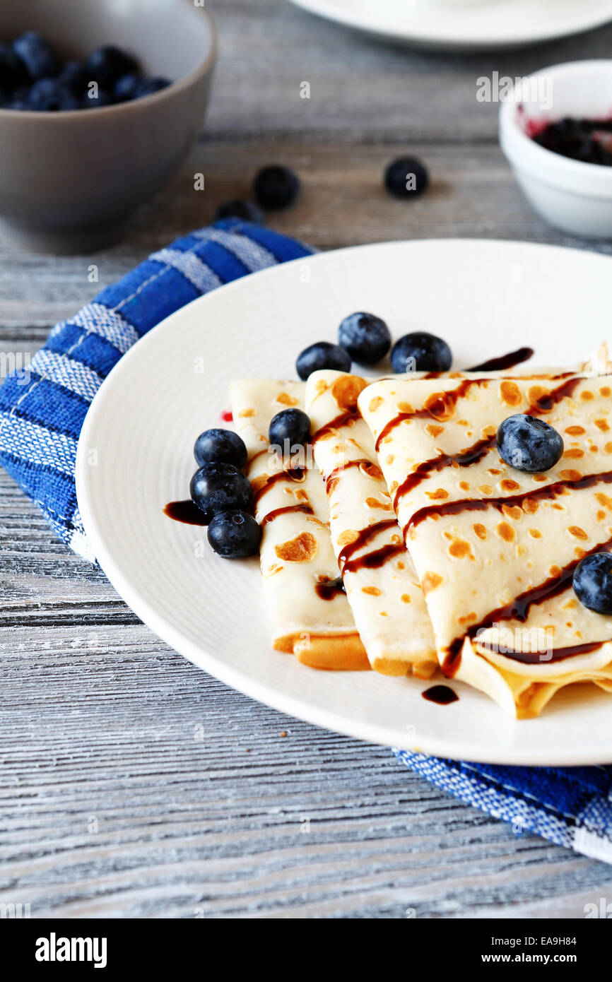 Sweet crepes on a white plate, side view Stock Photo - Alamy