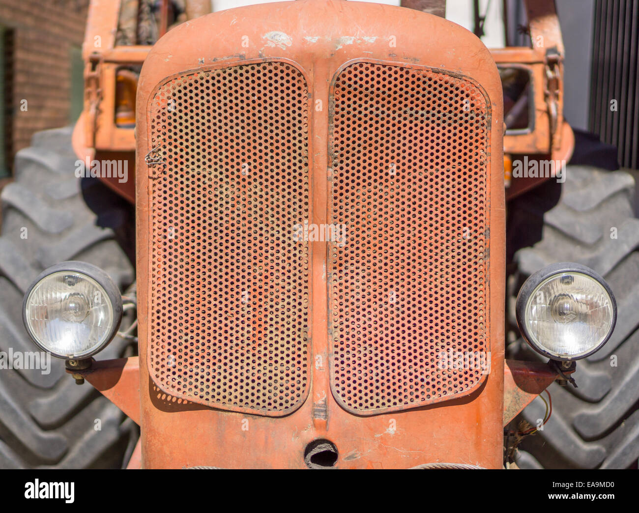 Front view of old red tractor grille and headlights Stock Photo - Alamy