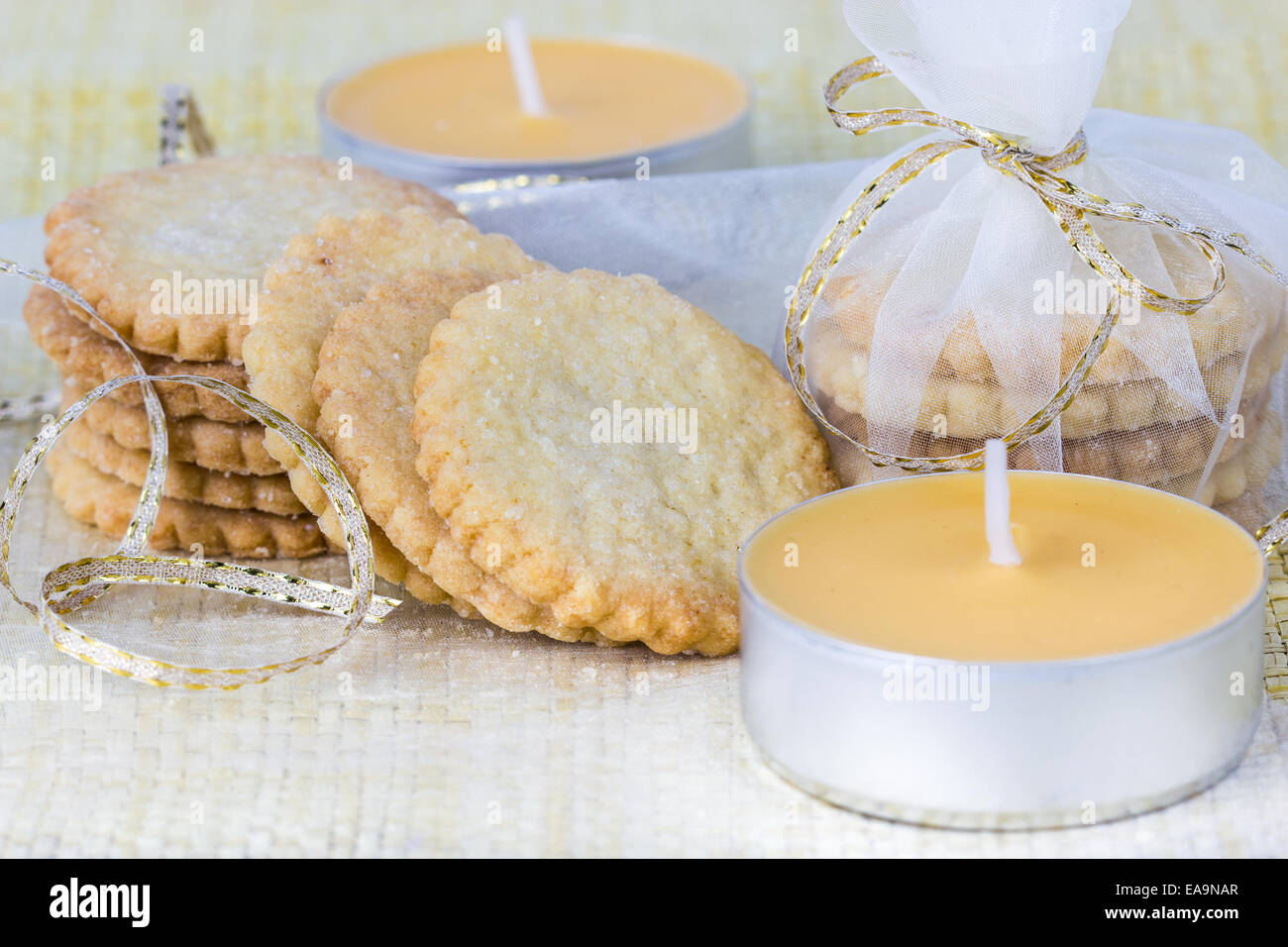Cookies with sugar and yellow candles Stock Photo - Alamy