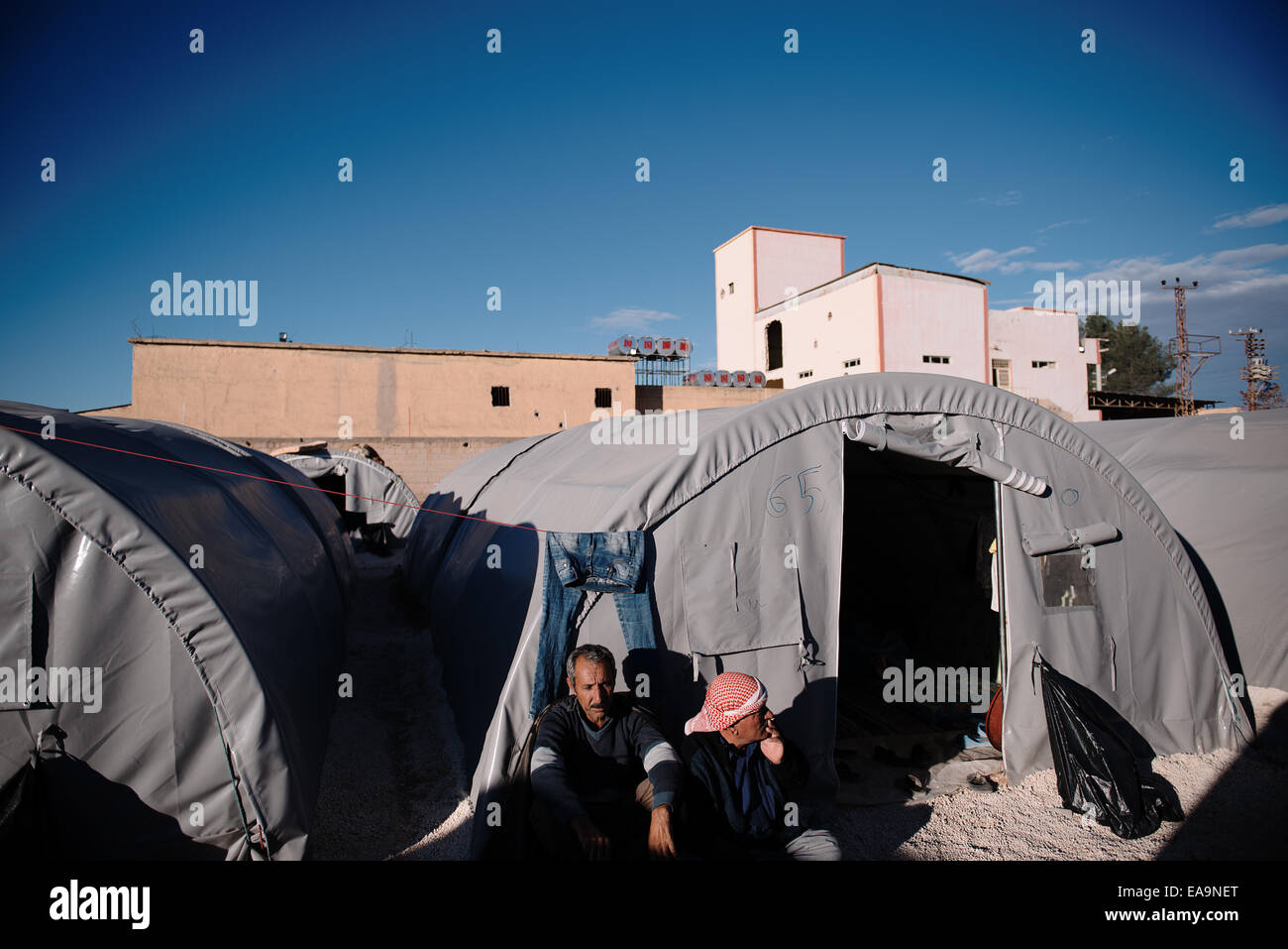 Kurdish refugees rest inside a refugee camp at the Turkish town of ...
