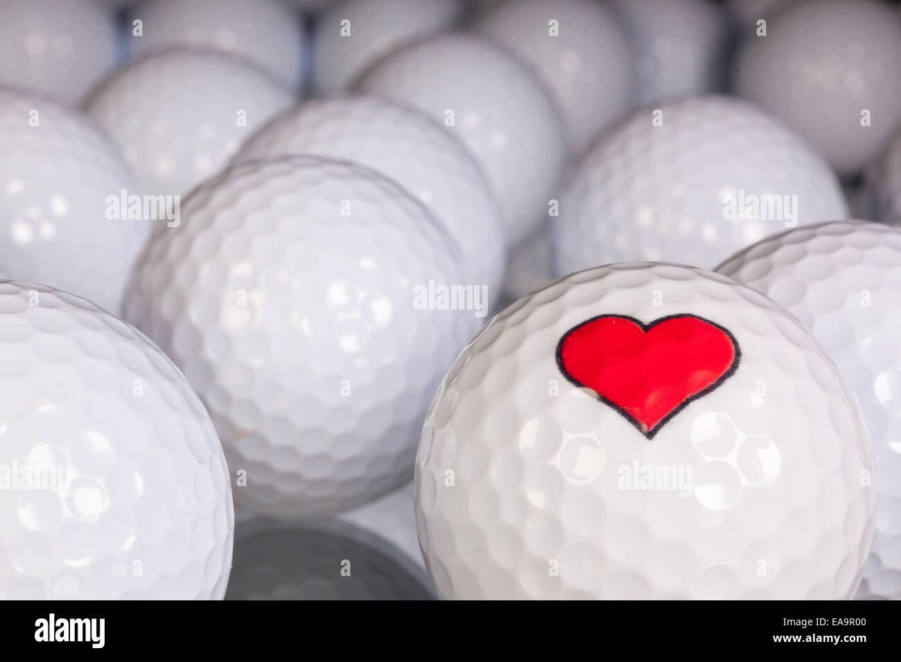 Golf balls with love symbol on the black glass table Stock Photo - Alamy