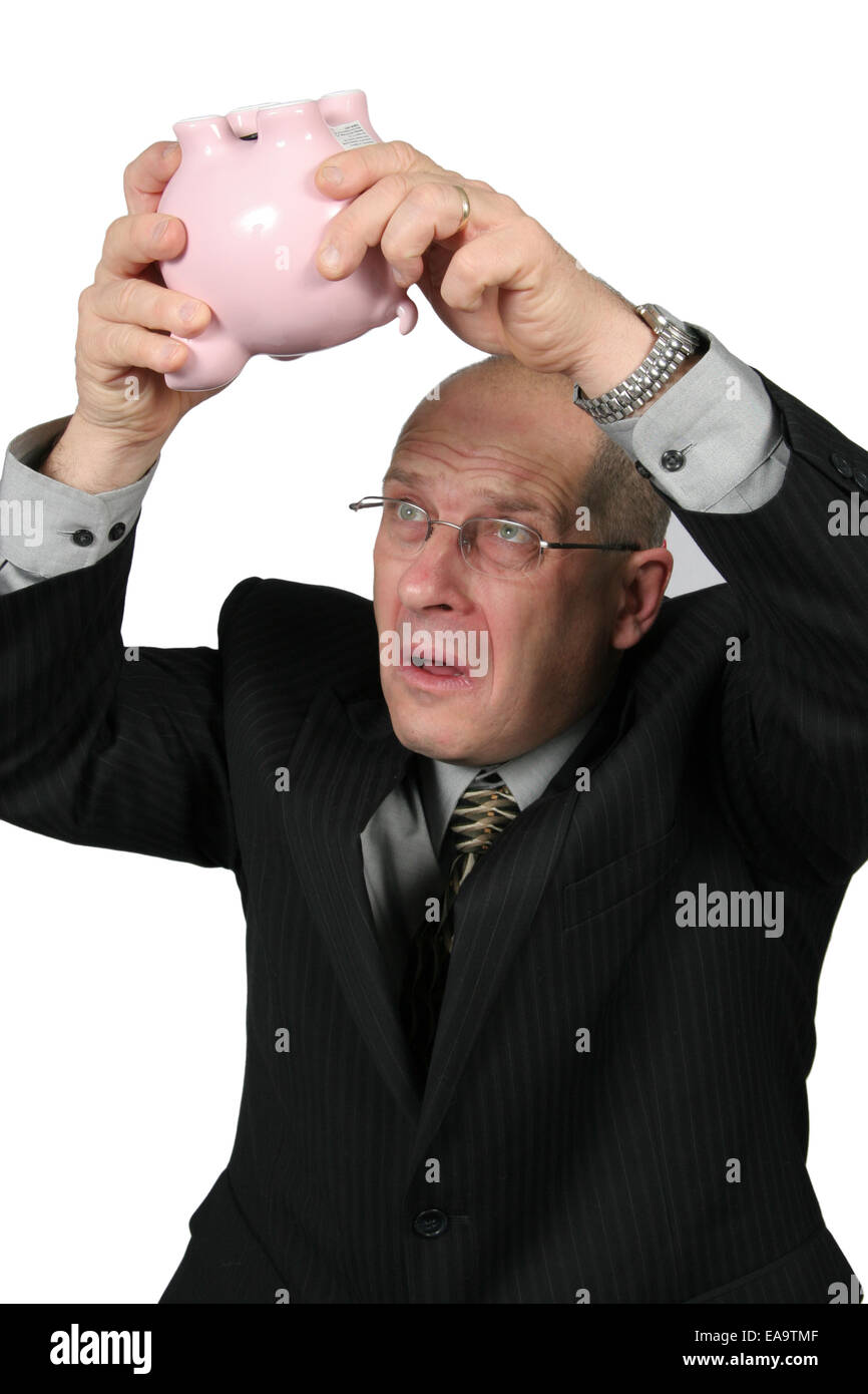 Business man holding Piggy Bank upside down in air - Where is the money ...