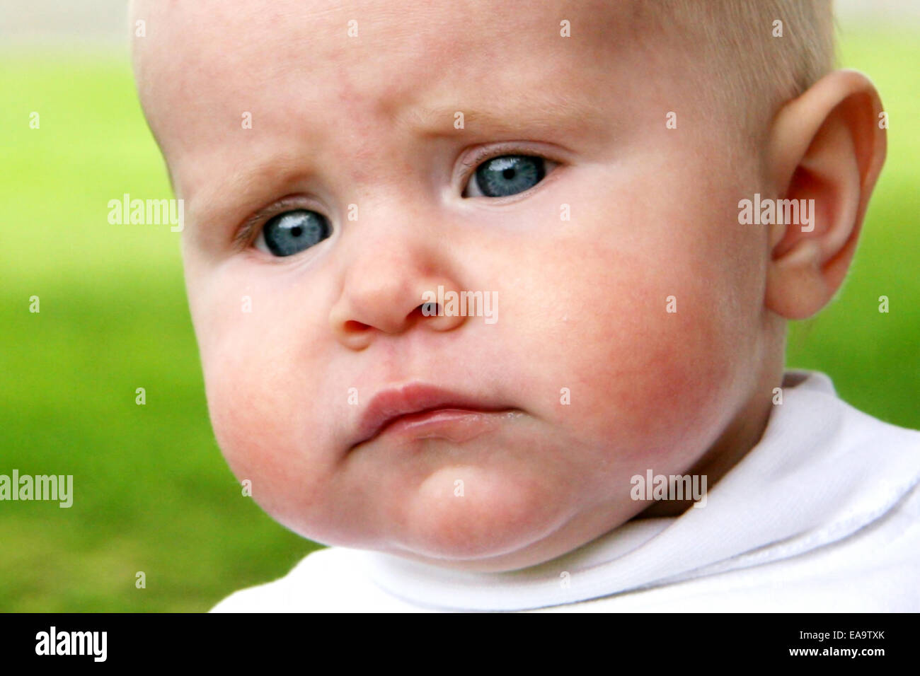 Baby taken closeup with sad face Stock Photo - Alamy