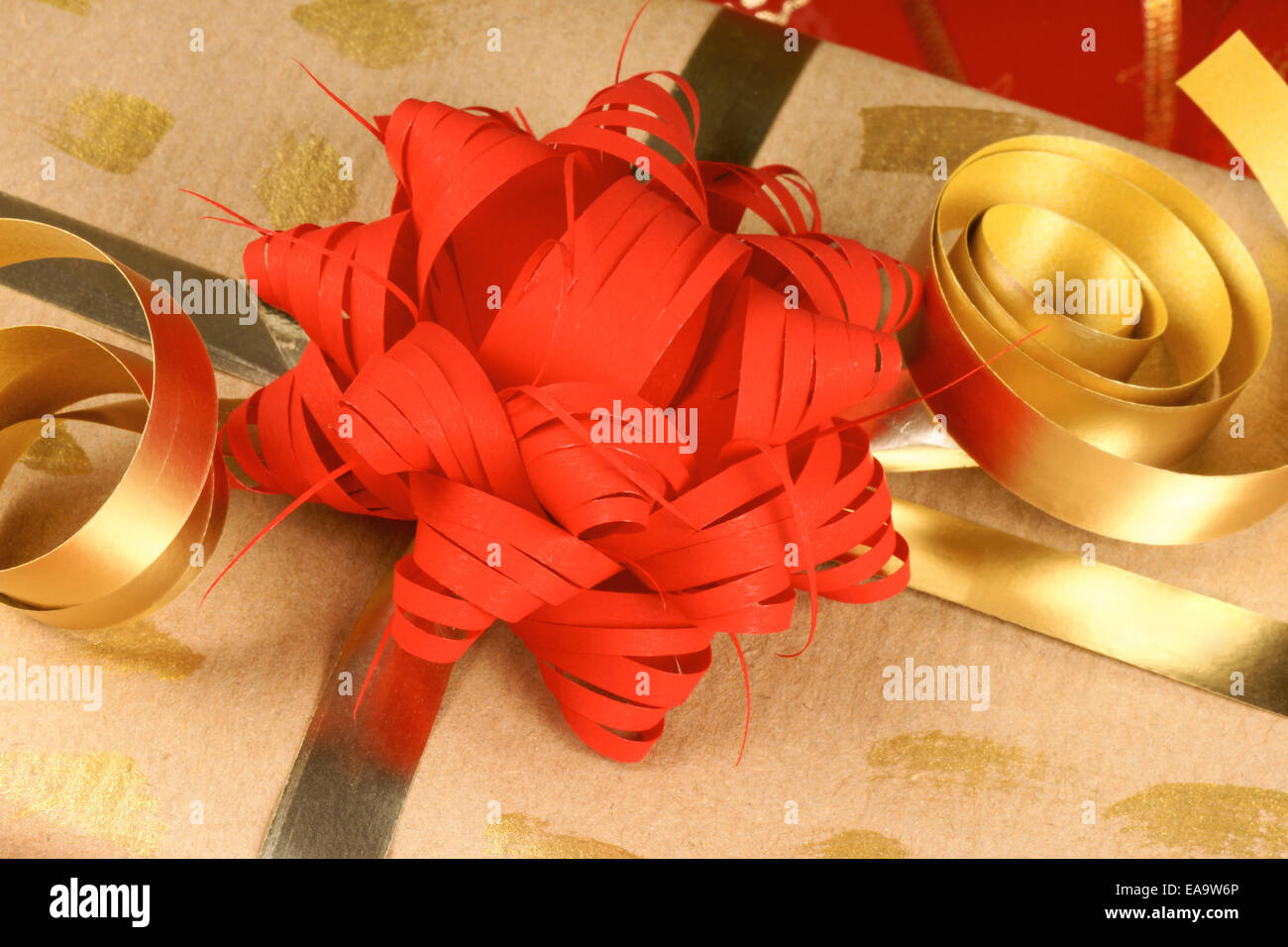 Close-up of a Christmas present with a red and golden ribbon Stock ...