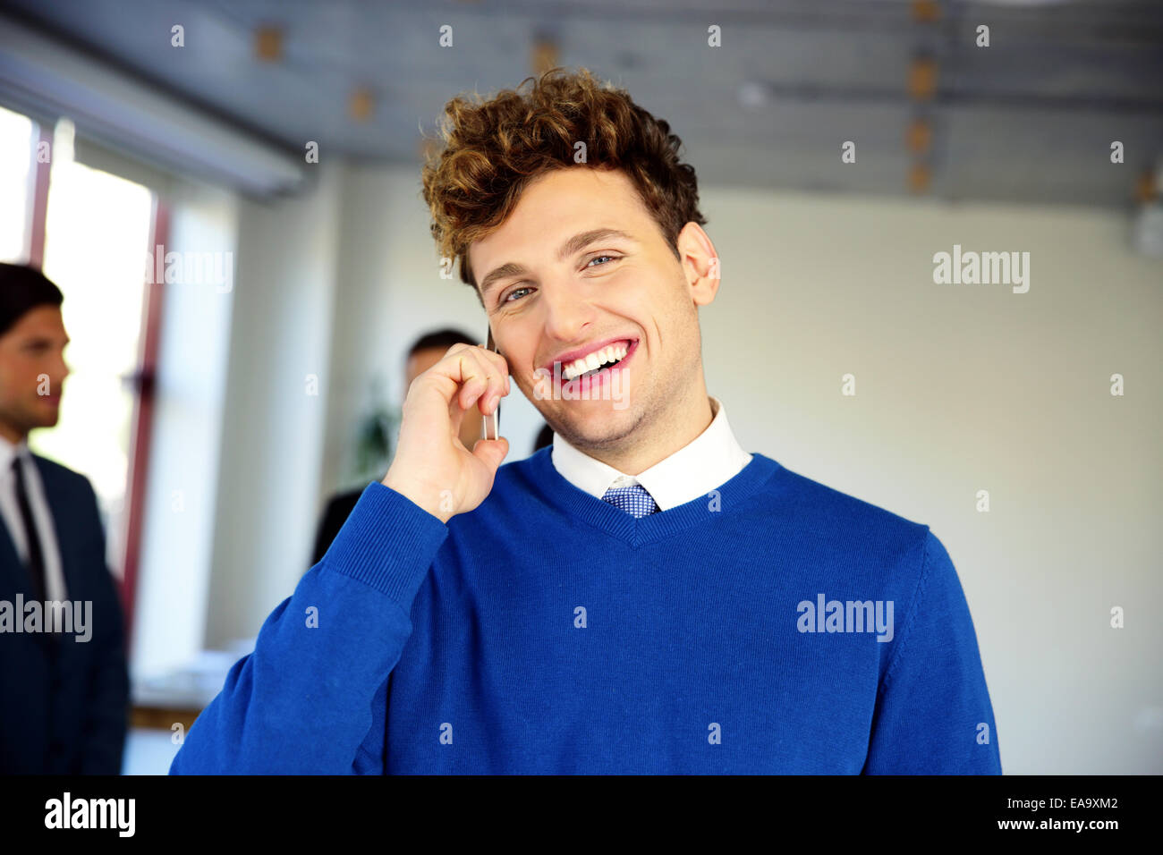 Laughing businessman talking on the phone in office Stock Photo - Alamy