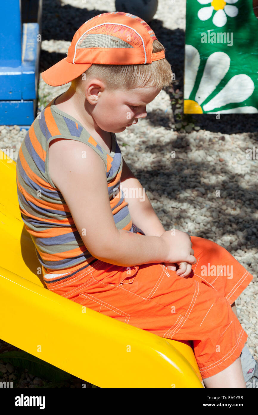 Sad boy sitting on childrens hi-res stock photography and images - Alamy