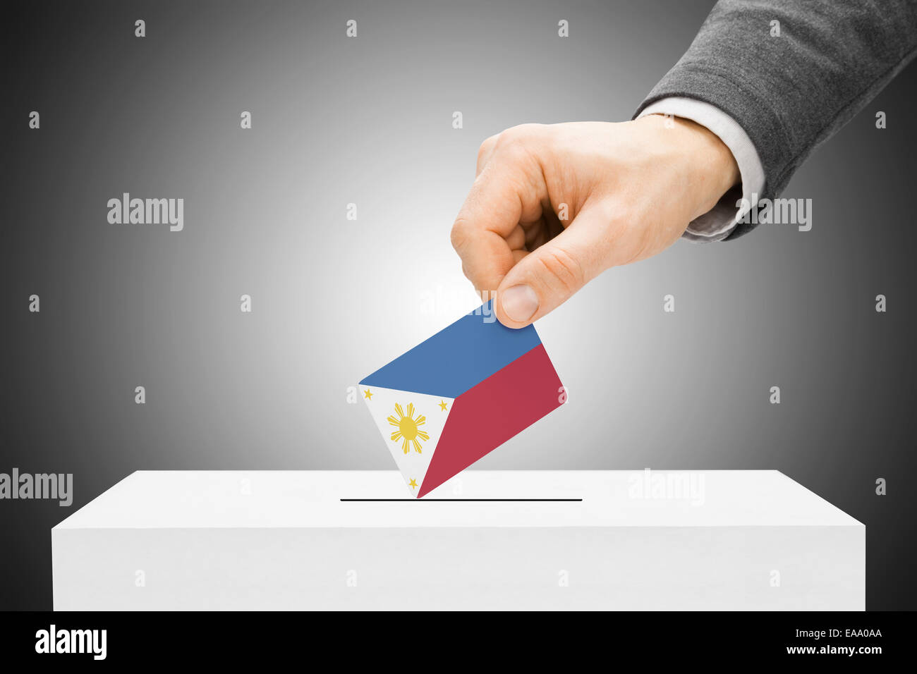 Voting concept - Male inserting flag into ballot box - Philippines ...