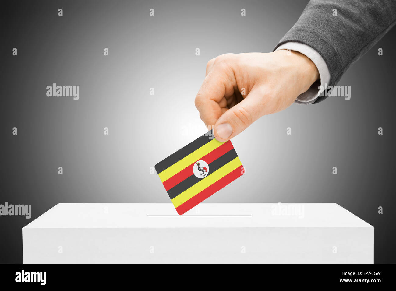 Voting concept - Male inserting flag into ballot box - Uganda Stock ...