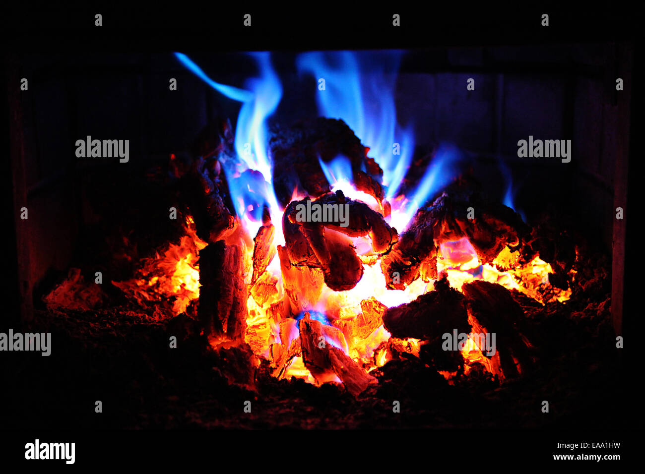 Fire in Fireplace with red and blue flames Stock Photo - Alamy