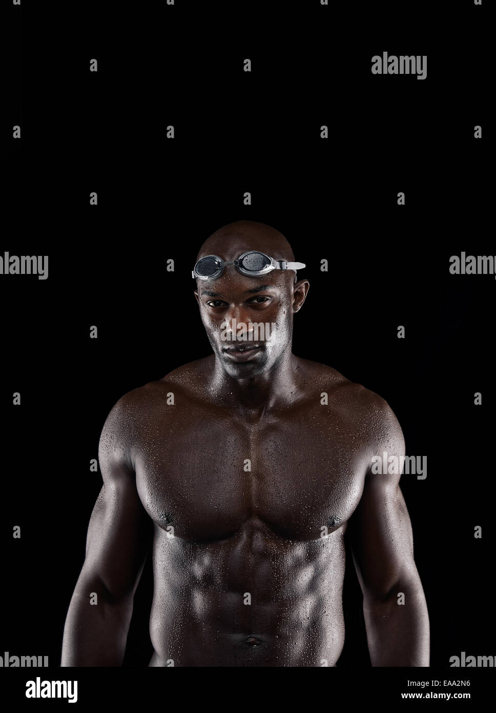 Portrait of strong young male swimmer posing for camera with copy space ...