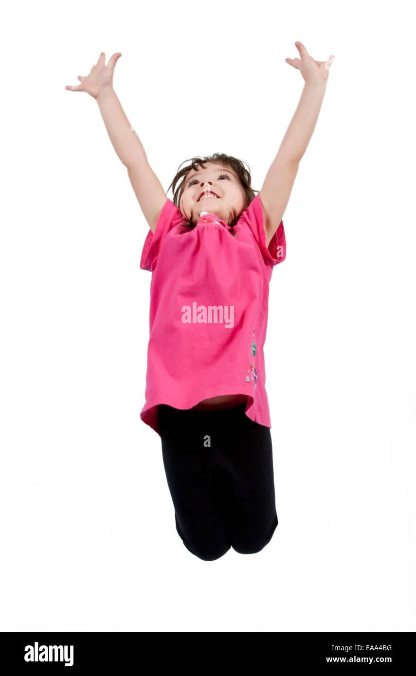 Adorable and happy little girl jumping in air. isolated on white ...