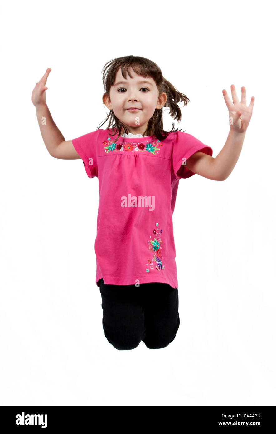 Adorable and happy little girl jumping in air. isolated on white ...