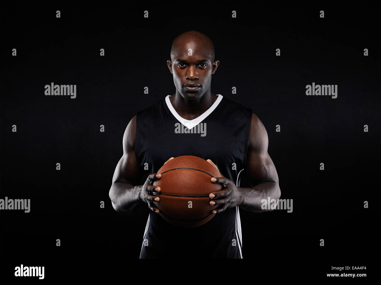 Portrait of muscular young male basketball player in uniform with a ...
