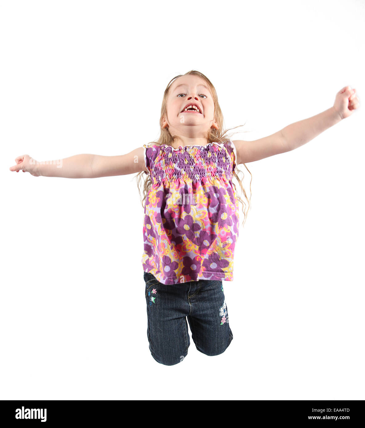 Adorable and happy little girl jumping in air. isolated on white ...