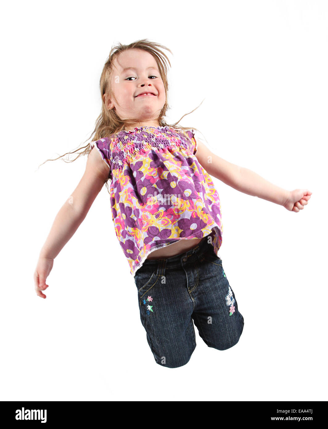 Adorable and happy little girl jumping in air. isolated on white ...