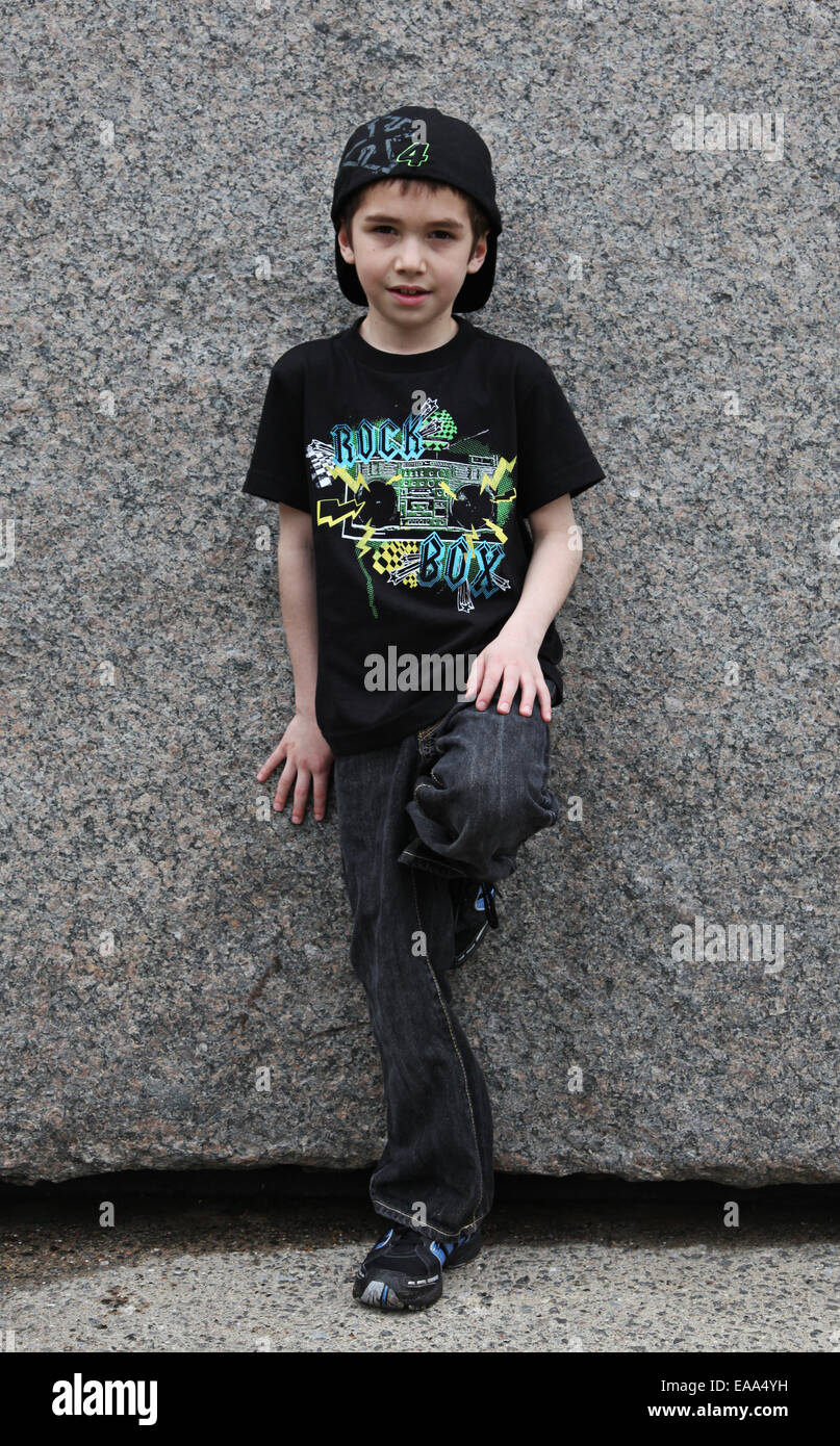 Boy posing on stone wall outside in spring Stock Photo - Alamy