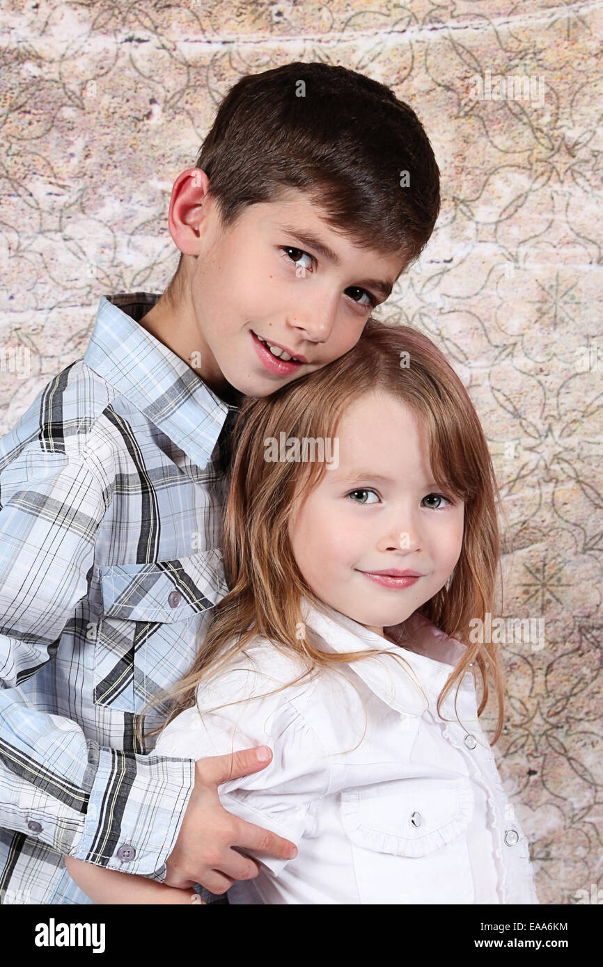 Adorable little brother and Sister on studio background Stock Photo - Alamy