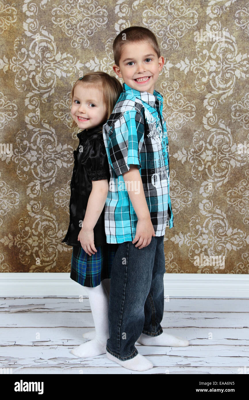 Adorable little brother and Sister on studio background Stock Photo - Alamy