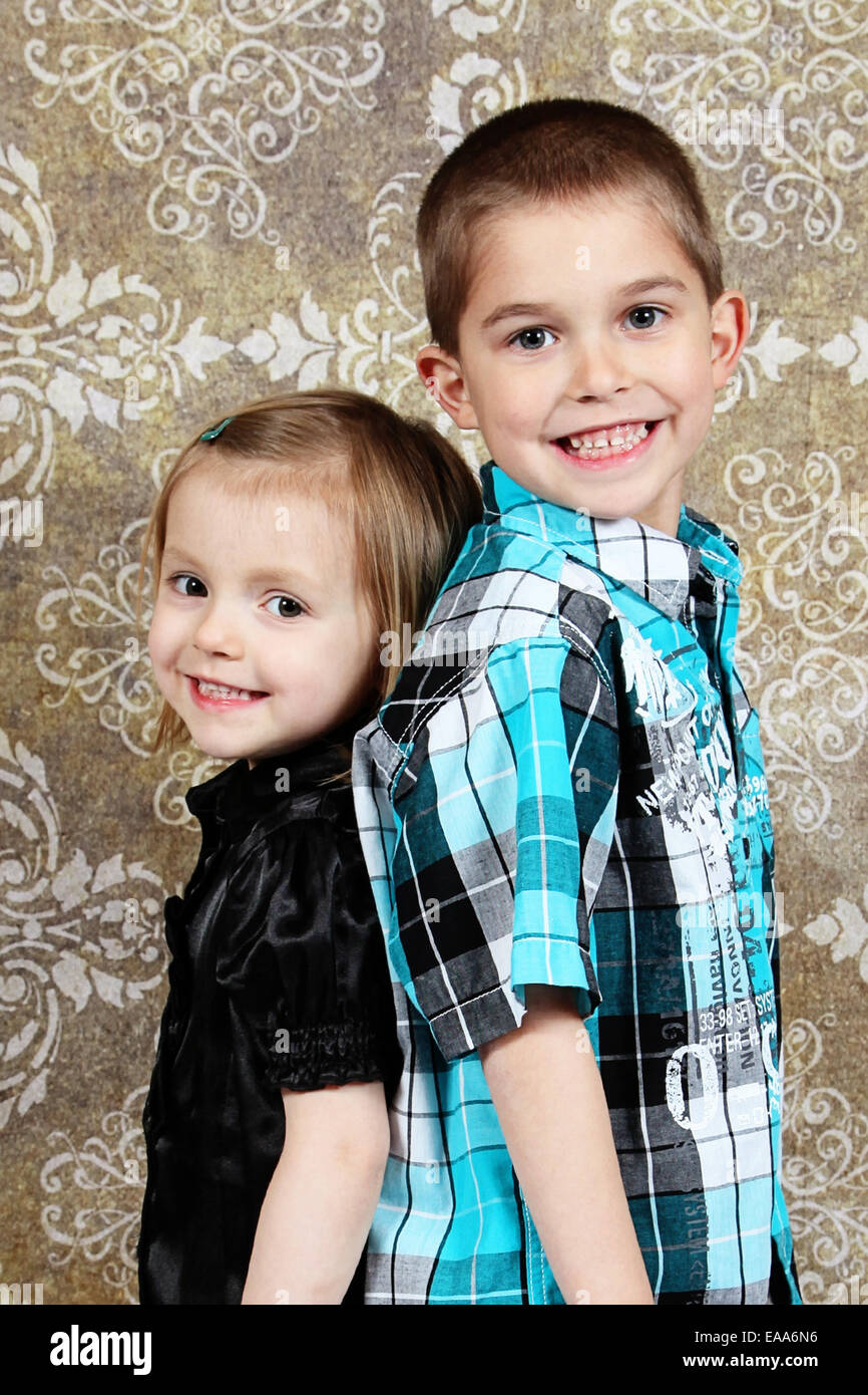 Adorable little brother and Sister on studio background Stock Photo - Alamy