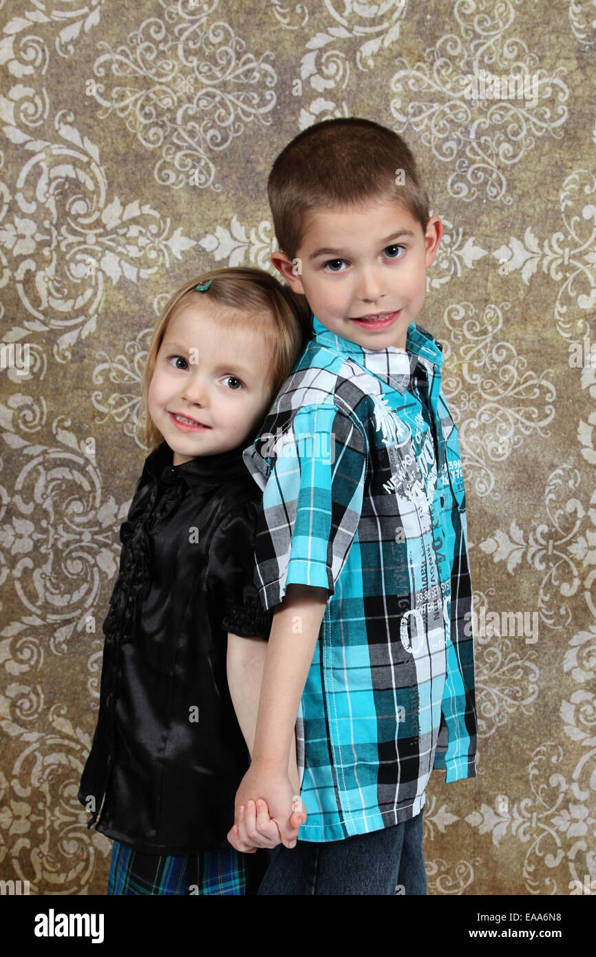 Adorable little brother and Sister on studio background Stock Photo - Alamy