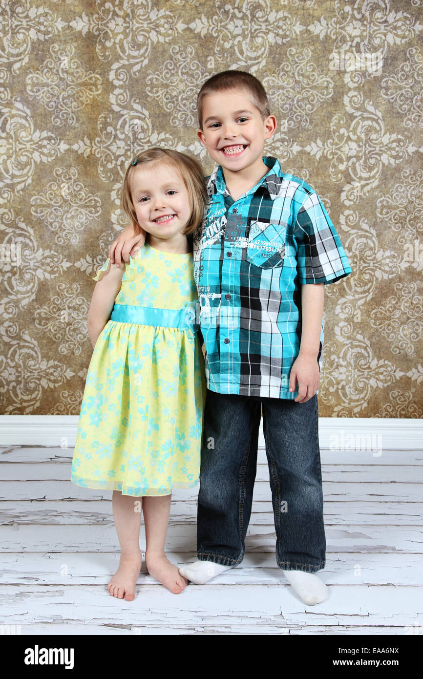 Adorable little brother and Sister on studio background Stock Photo - Alamy