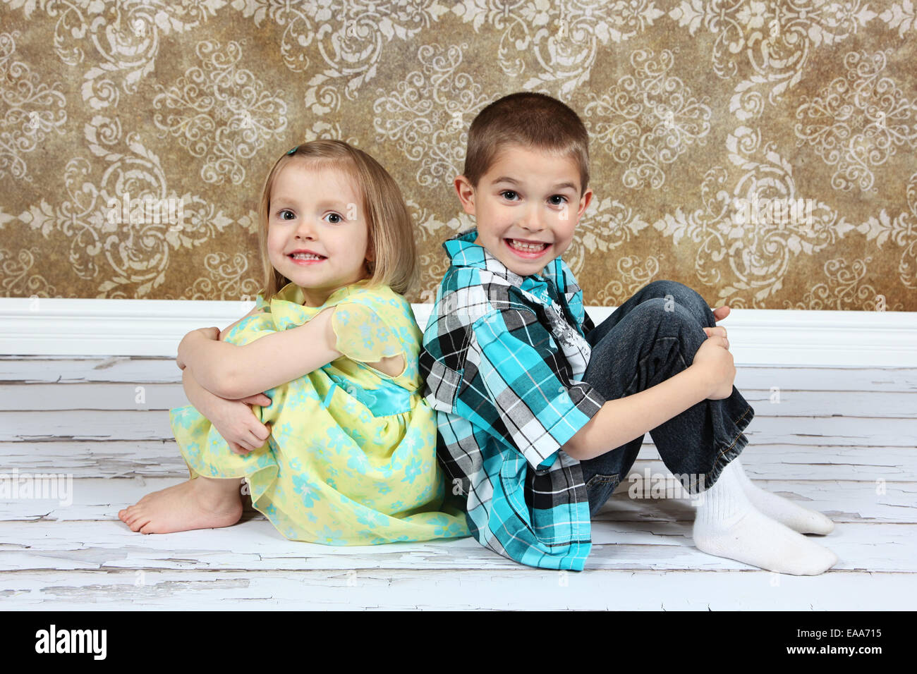Adorable little brother and Sister on studio background Stock Photo - Alamy