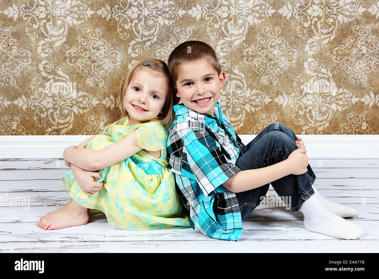 Adorable little brother and Sister on studio background Stock Photo - Alamy