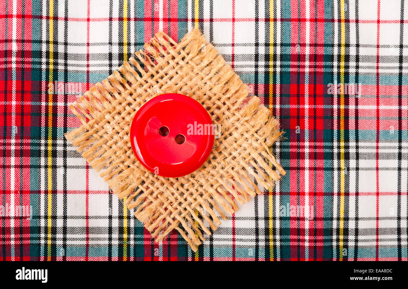 Red button on checkered background Stock Photo - Alamy