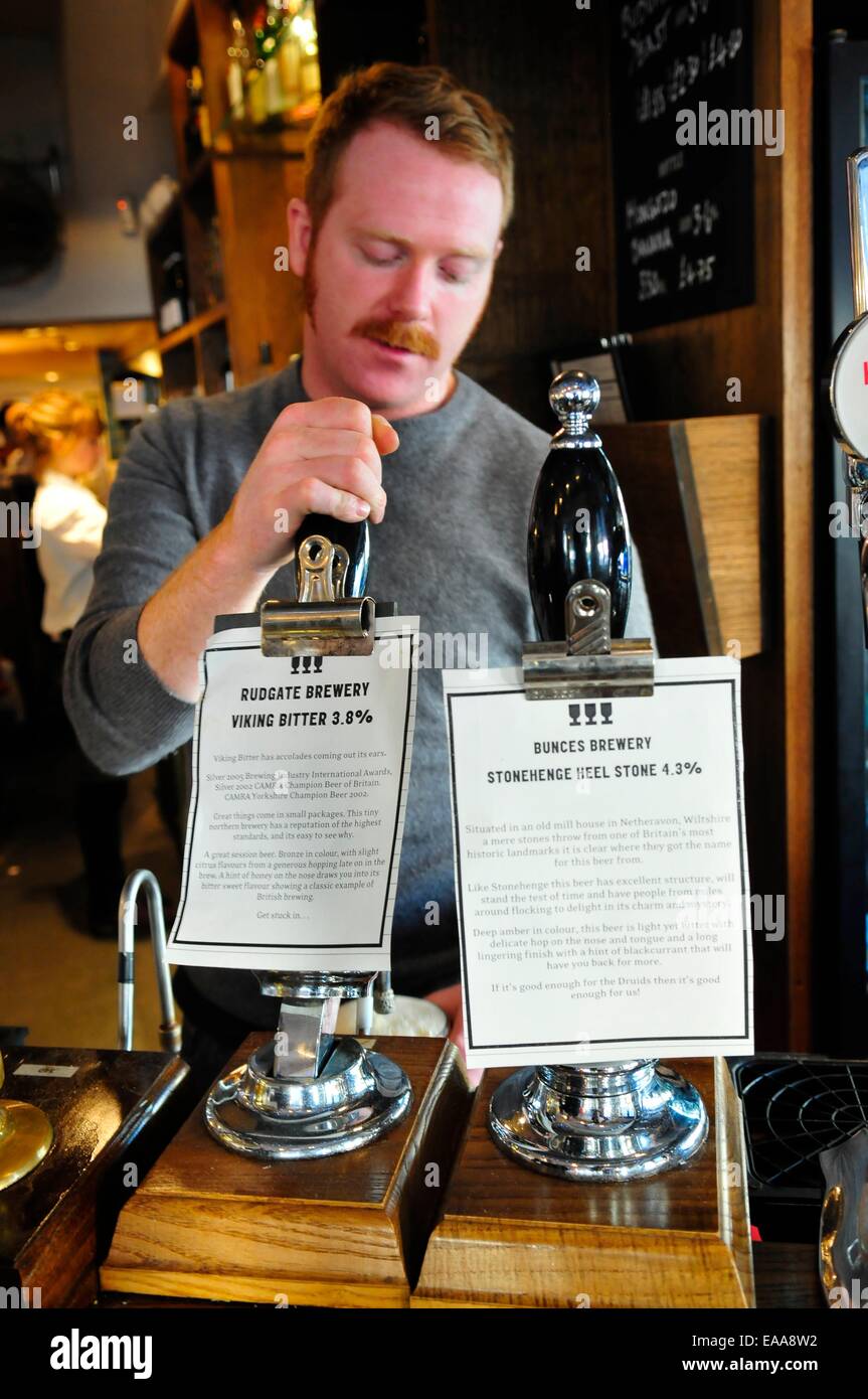 Barman pulling a pint of beer at The Draft House pub in Battersea ...