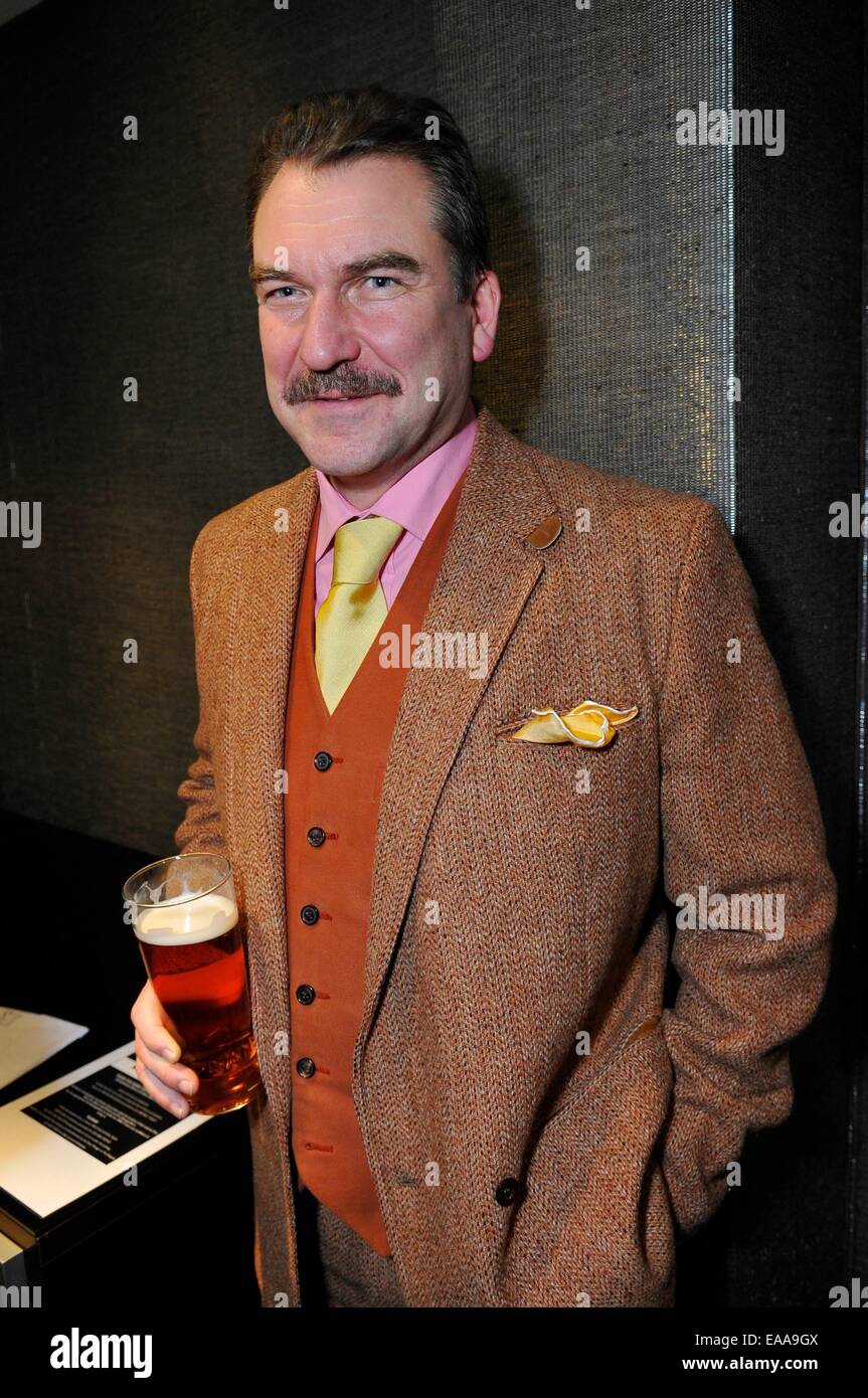 Colour photograph of a man holding a pint of beer hi-res stock ...