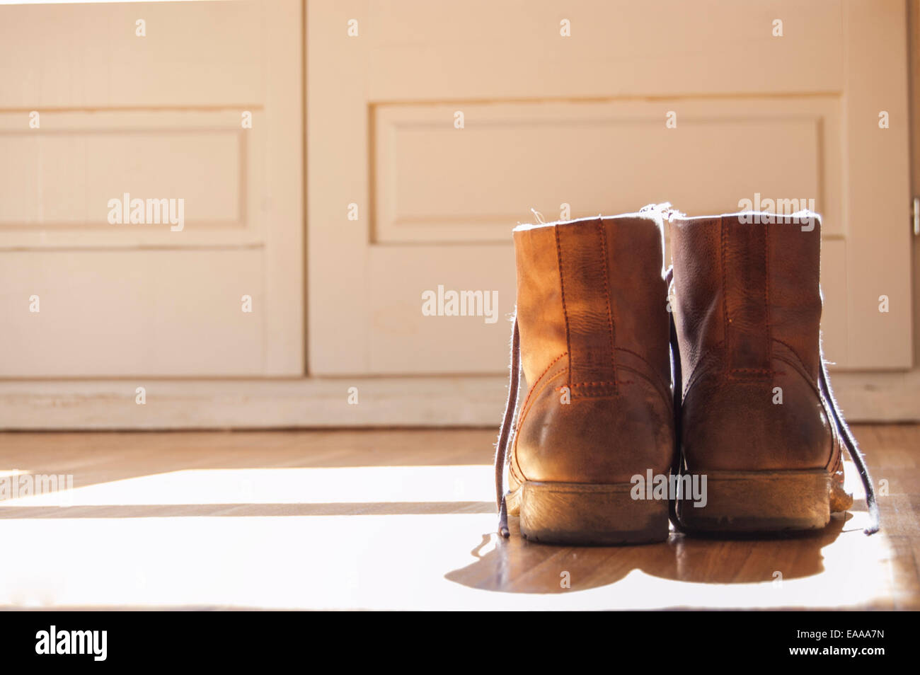 Boots under the sun light coming throw the window Stock Photo - Alamy