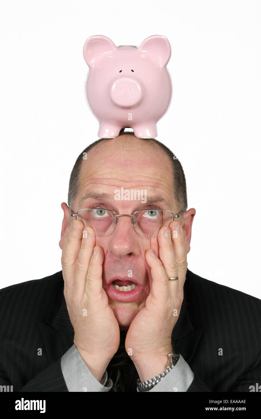 Business man with Piggy Bank on top of his head and hands on face Stock ...