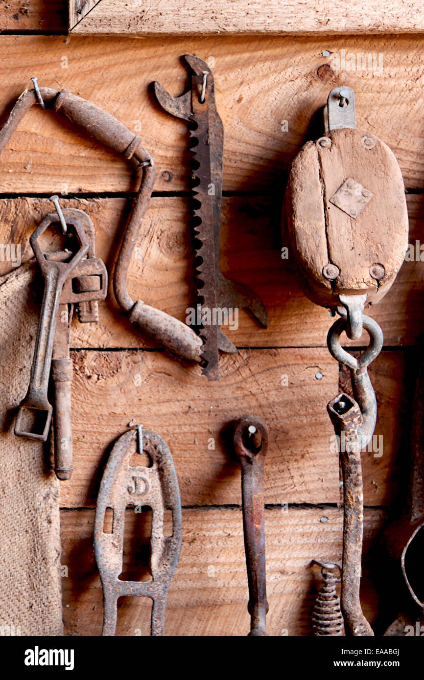 Assorted old work tools on wooden wall Stock Photo - Alamy