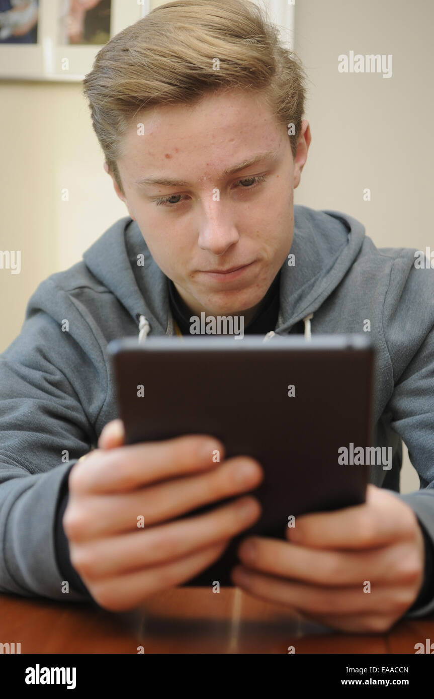 Teenage Boy Using An Apple iPad Mini Tablet Stock Photo - Alamy
