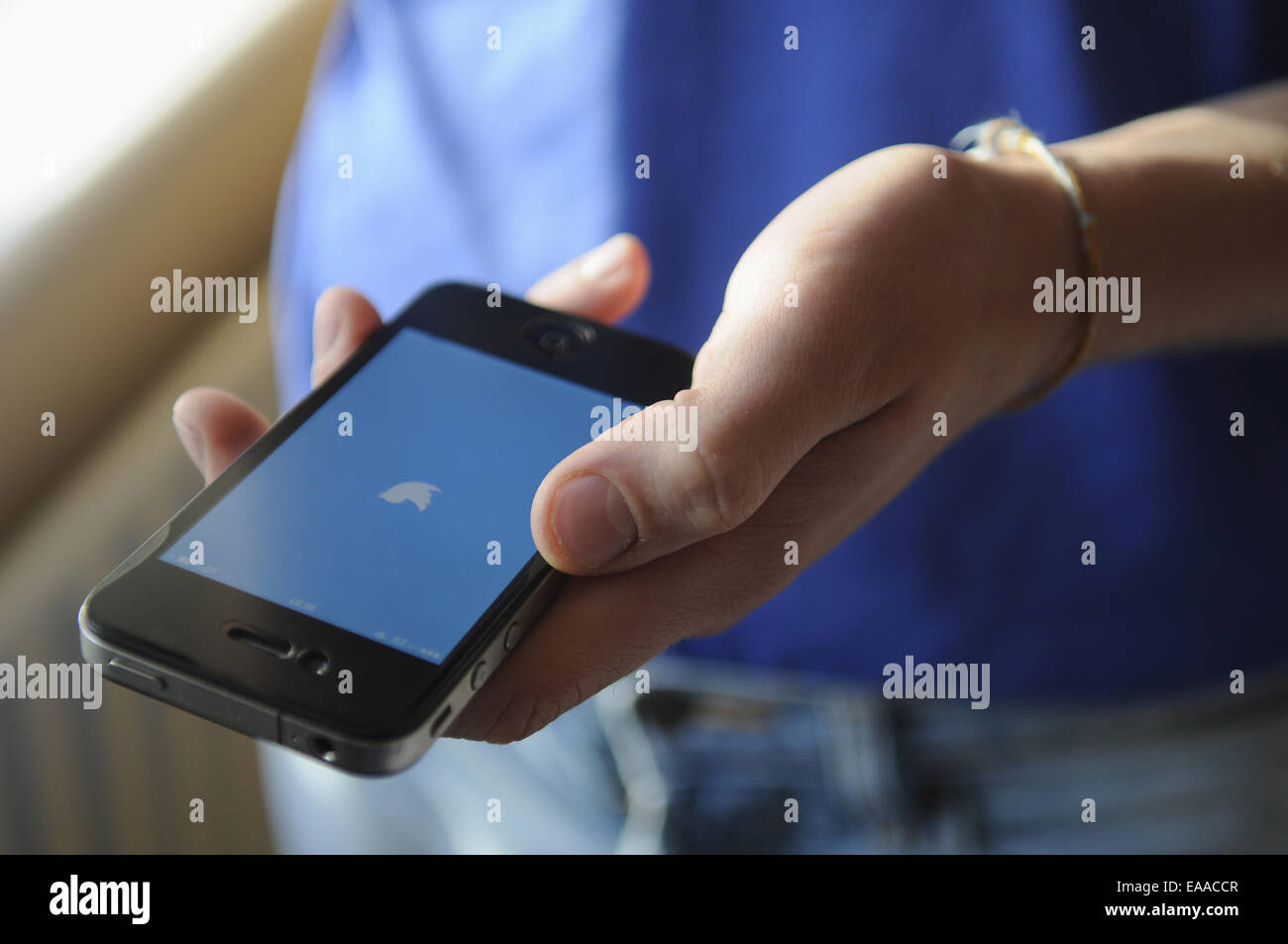 Boy holding iphone hi-res stock photography and images - Alamy