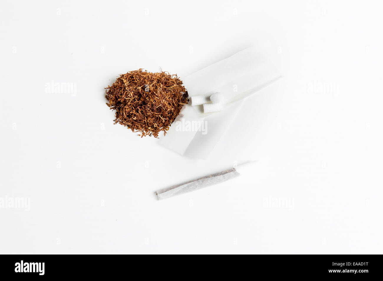 Tobacco, filters and cigarette paper with a ready handmade cigarette ...