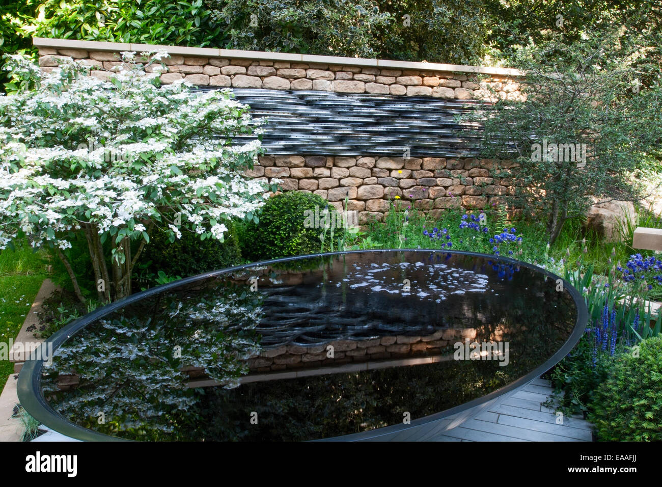 Chelsea Flower Show 2014. Formal pool with a wildlife meadow backdrop ...