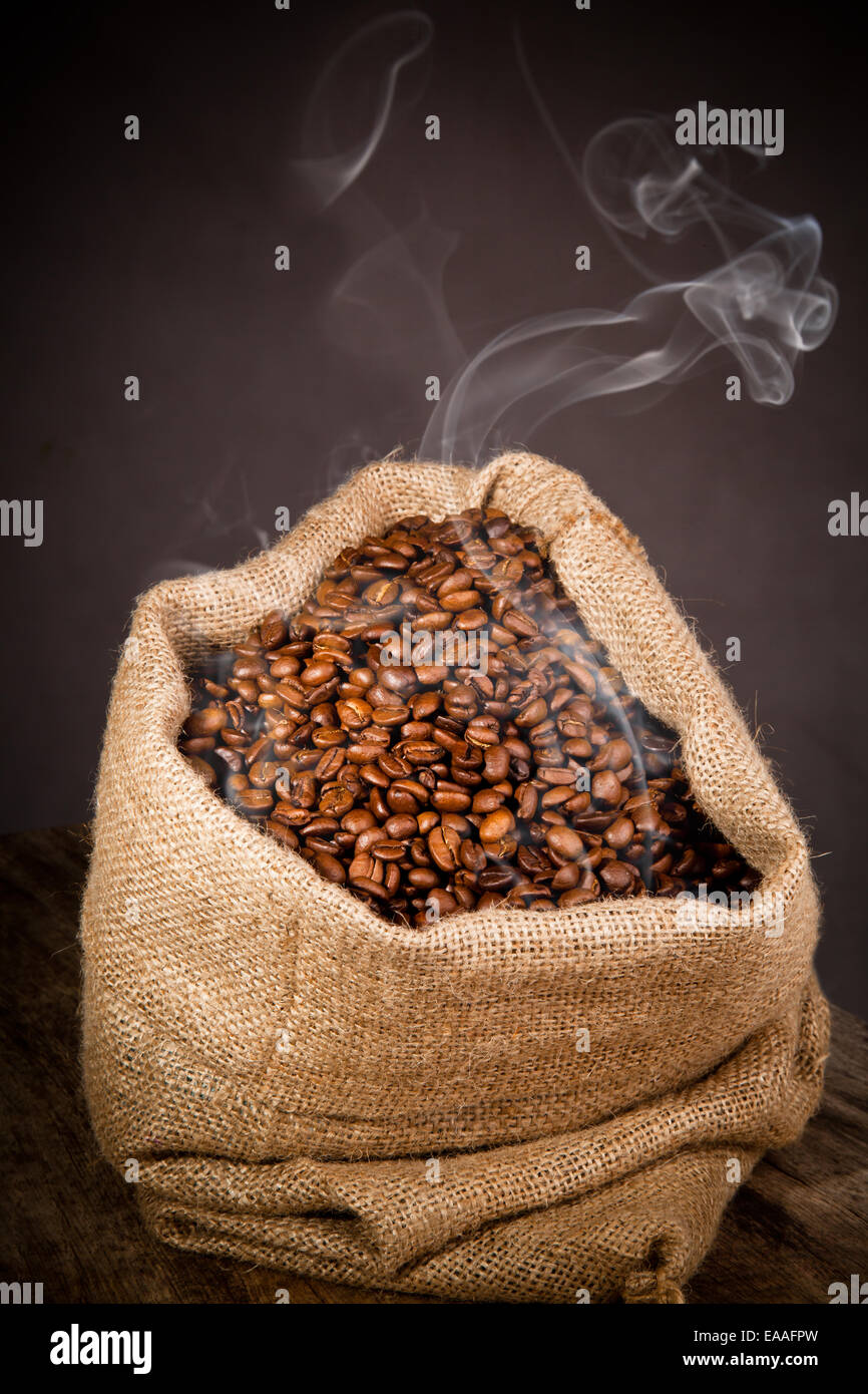 Burlap bag full of coffee beans with smoke Stock Photo - Alamy