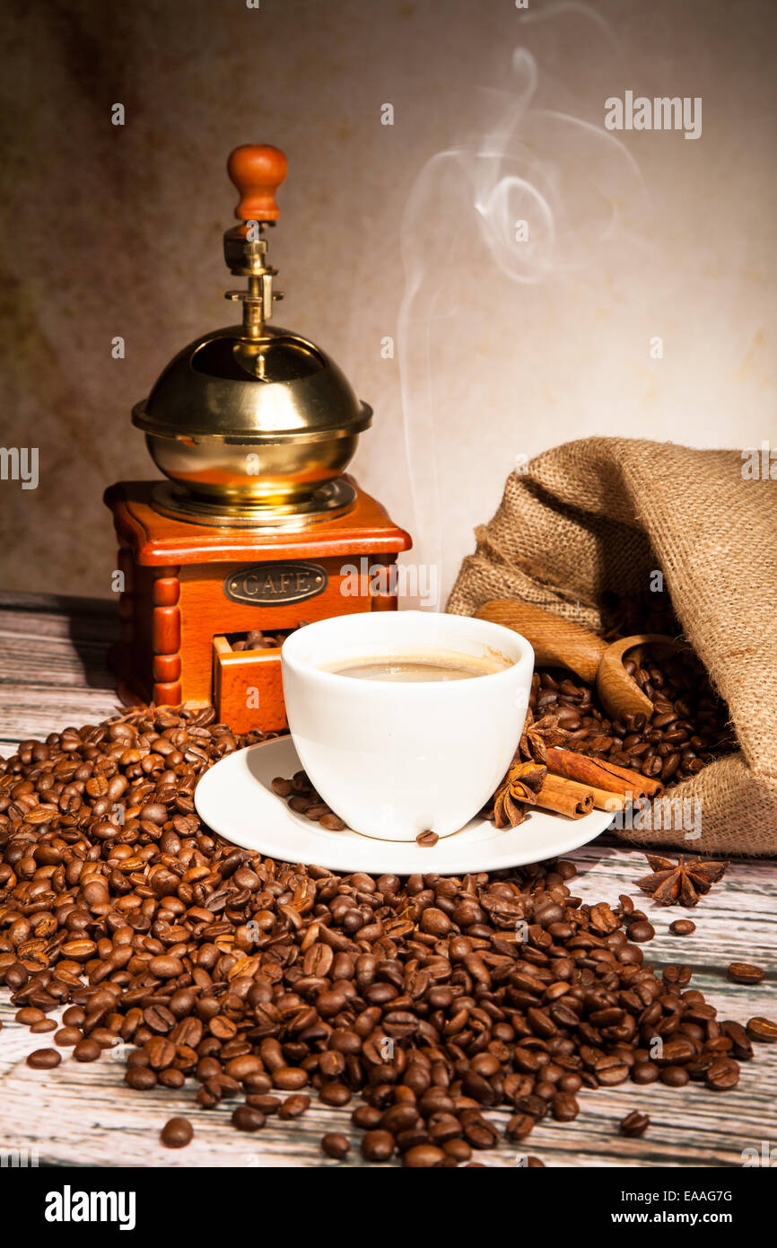 Coffee still life with wooden grinder and cup Stock Photo - Alamy