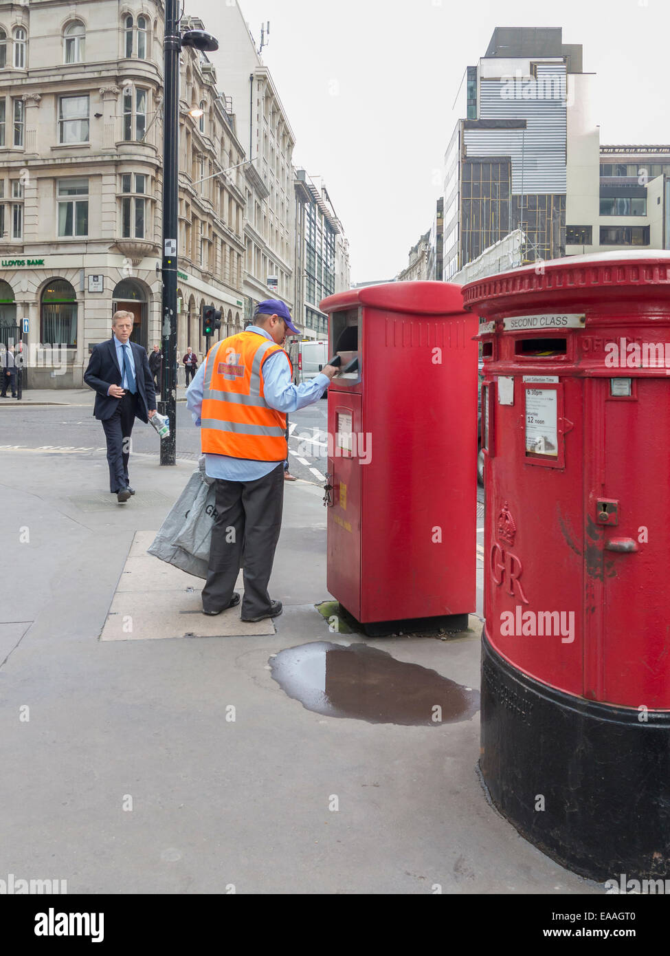Postman emptying red postbox, London, UK Stock Photo - Alamy