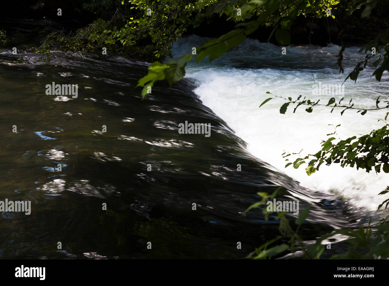 River water rushes over a weir Stock Photo - Alamy