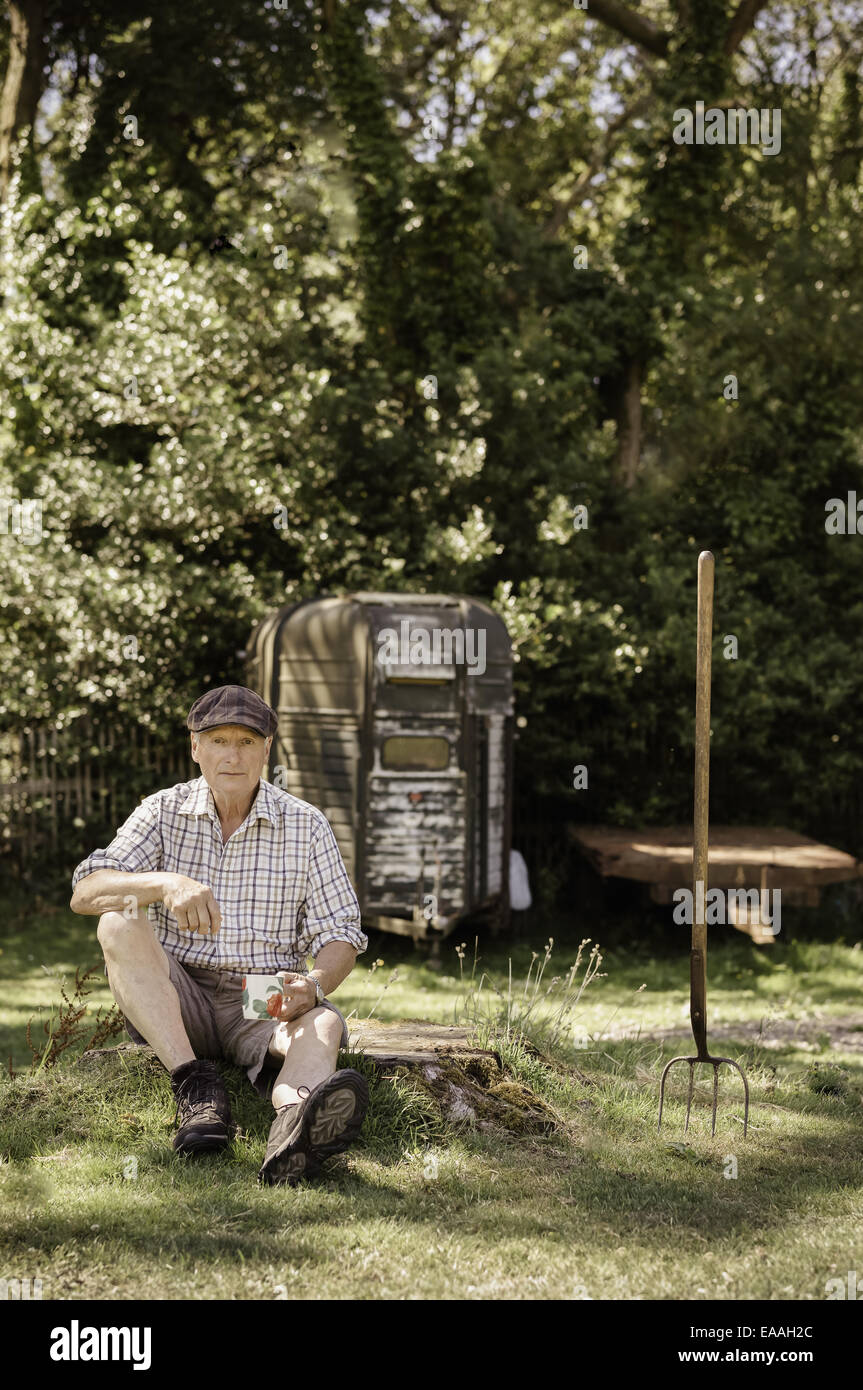 Man sitting in a garden Stock Photo - Alamy