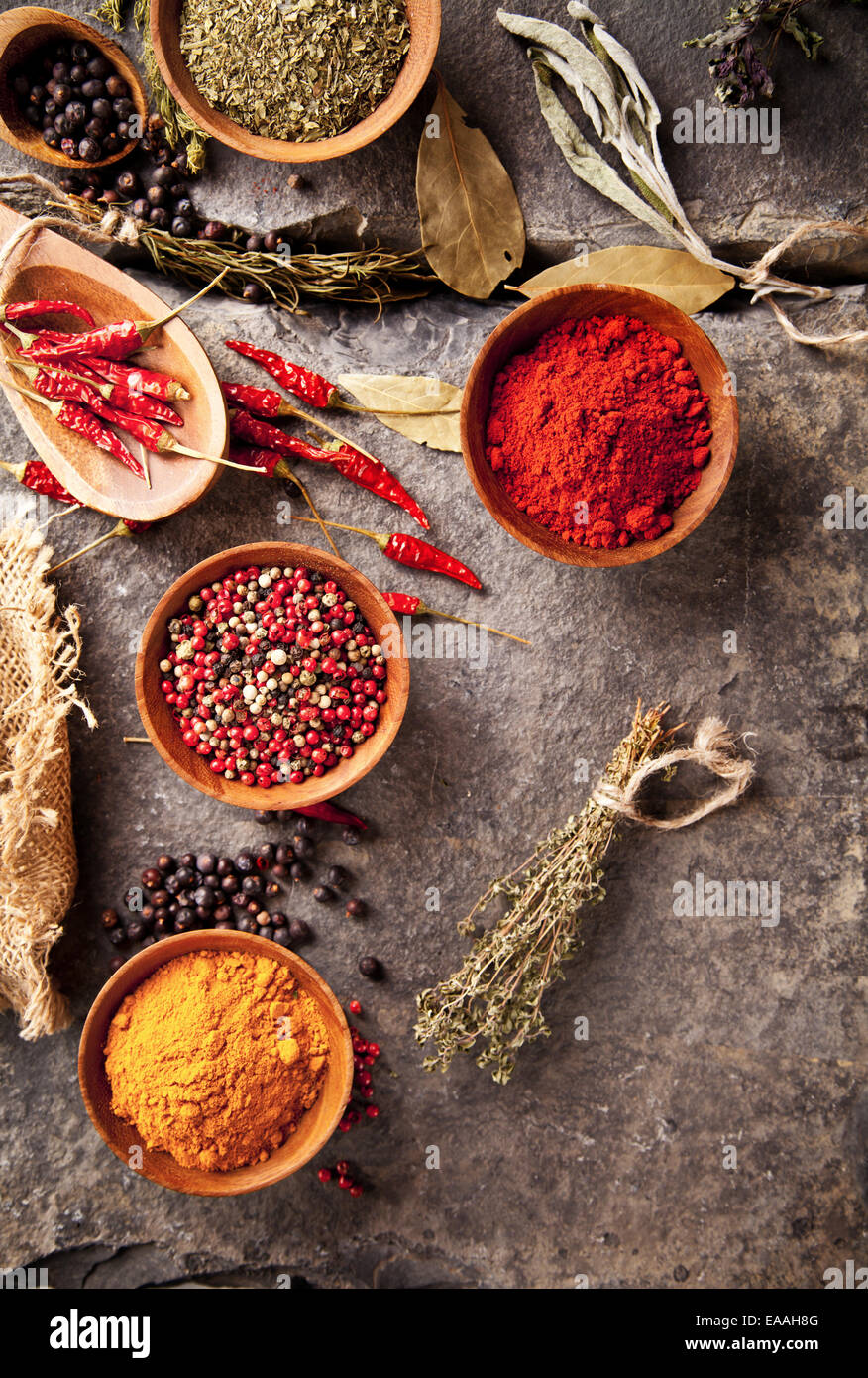 Various spices in wooden bowls on stone surface Stock Photo - Alamy